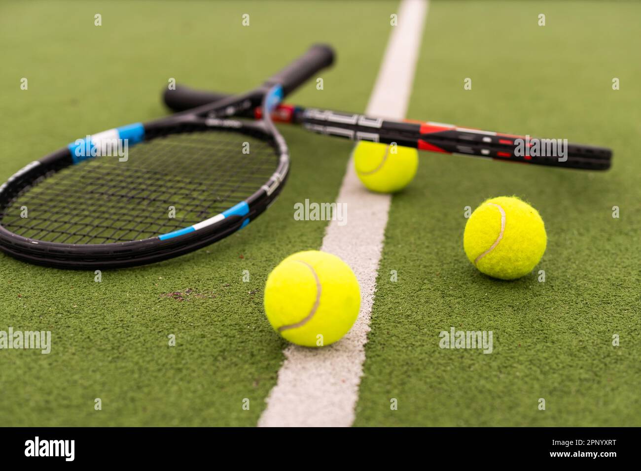 Tennis racket and tennis ball on court Stock Photo - Alamy