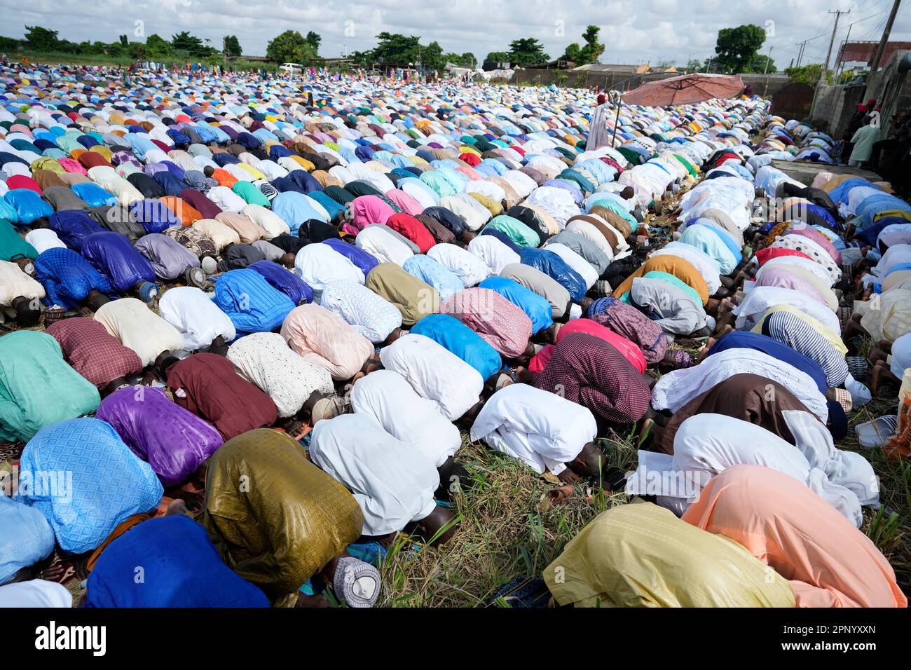Nigerian Muslims pray in an open ground field during the Eid al-Fitr ...