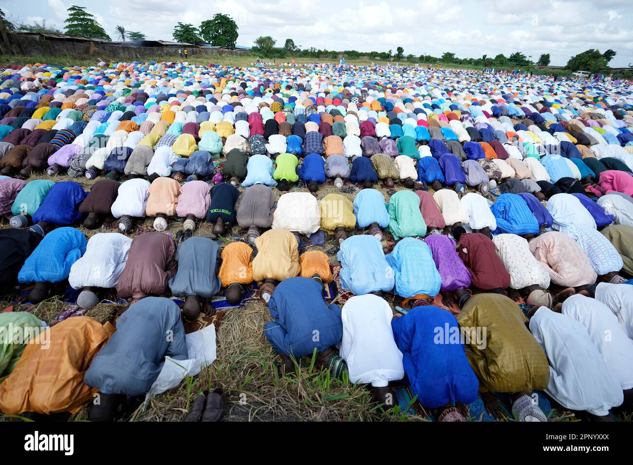 Nigerian Muslims pray in an open ground field during the Eid al-Fitr ...