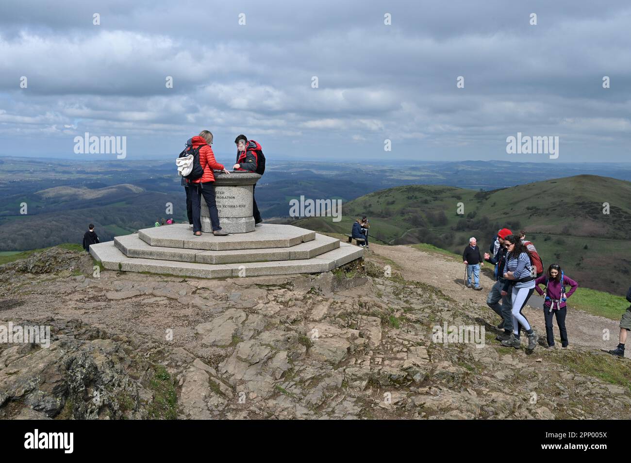 Walkers gather by the memorial stone on the summit of the ...