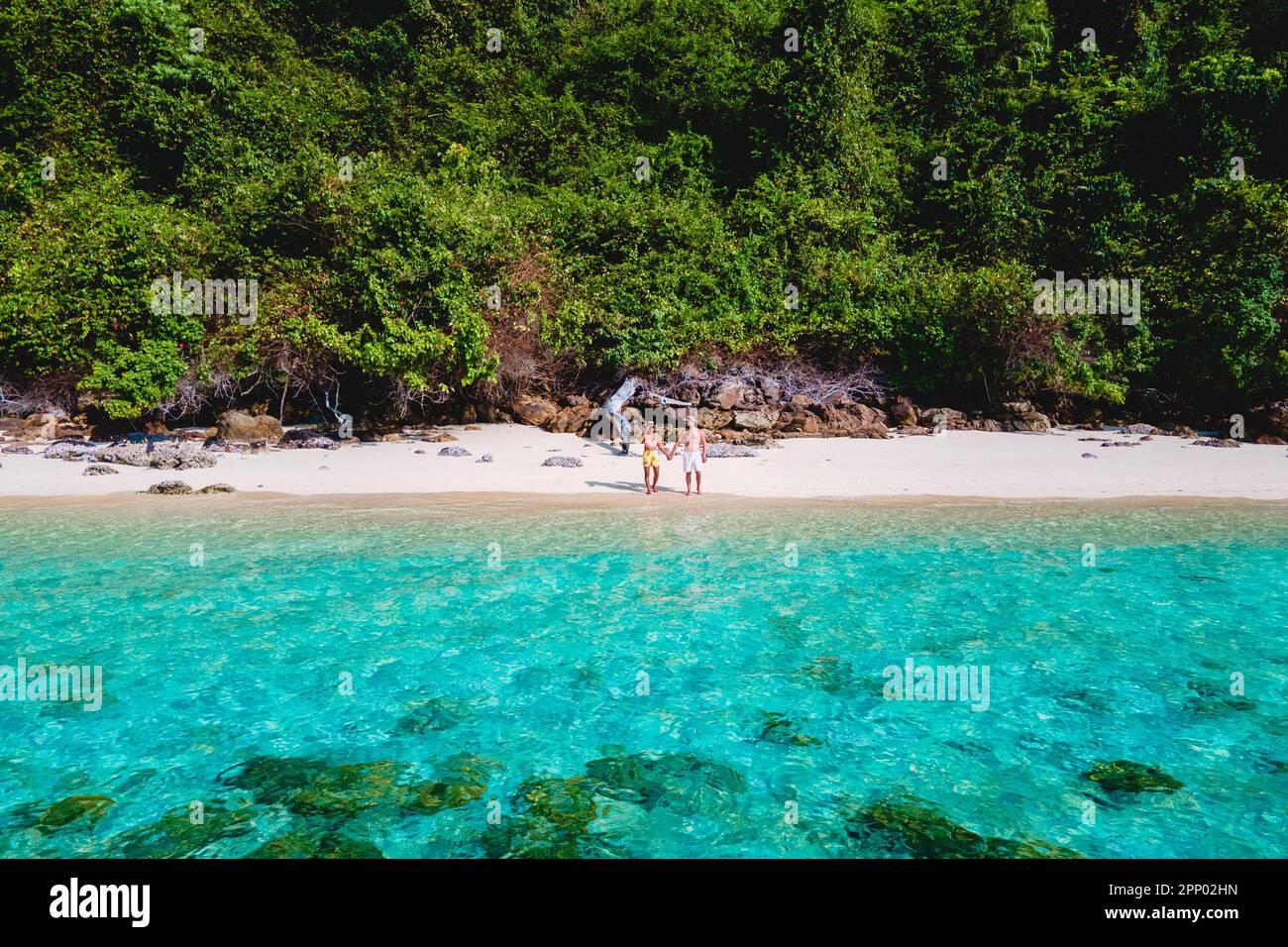 a couple walking on the beach of Koh Kradan Island, a tropical beach ...