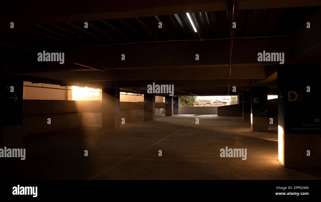 An urban parking garage with a gritty aesthetic, featuring framed ...