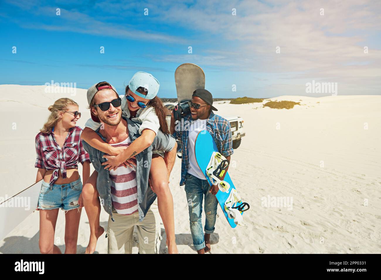 Off on a sand boarding adventure. a group of young friends sandboarding ...