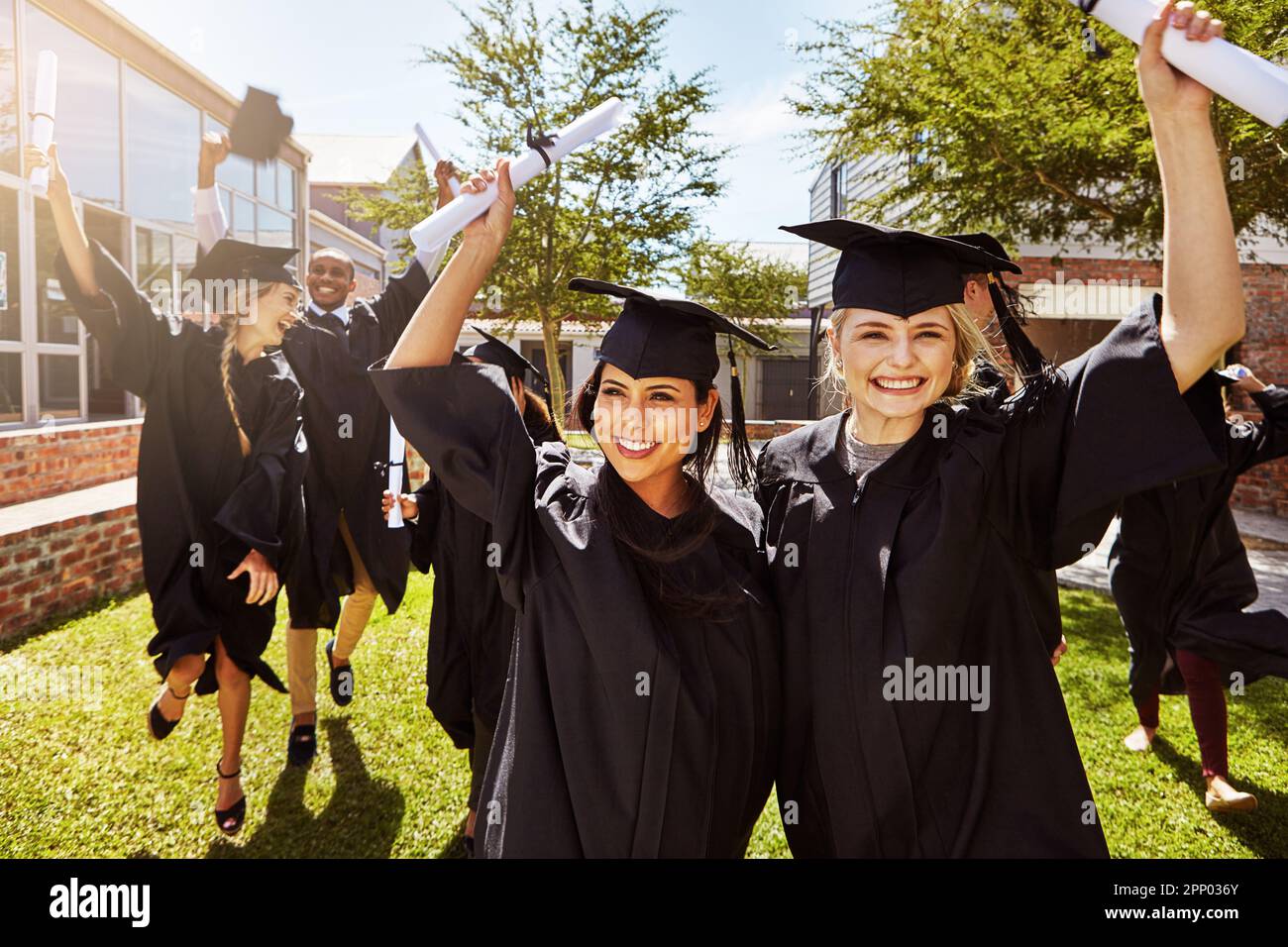 Celebrating the end of their studies. Portrait of a group of smiling ...