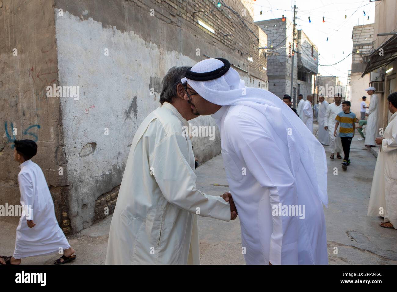 Iraqi Muslims greet each other after prayers on the first day of Eid Al ...