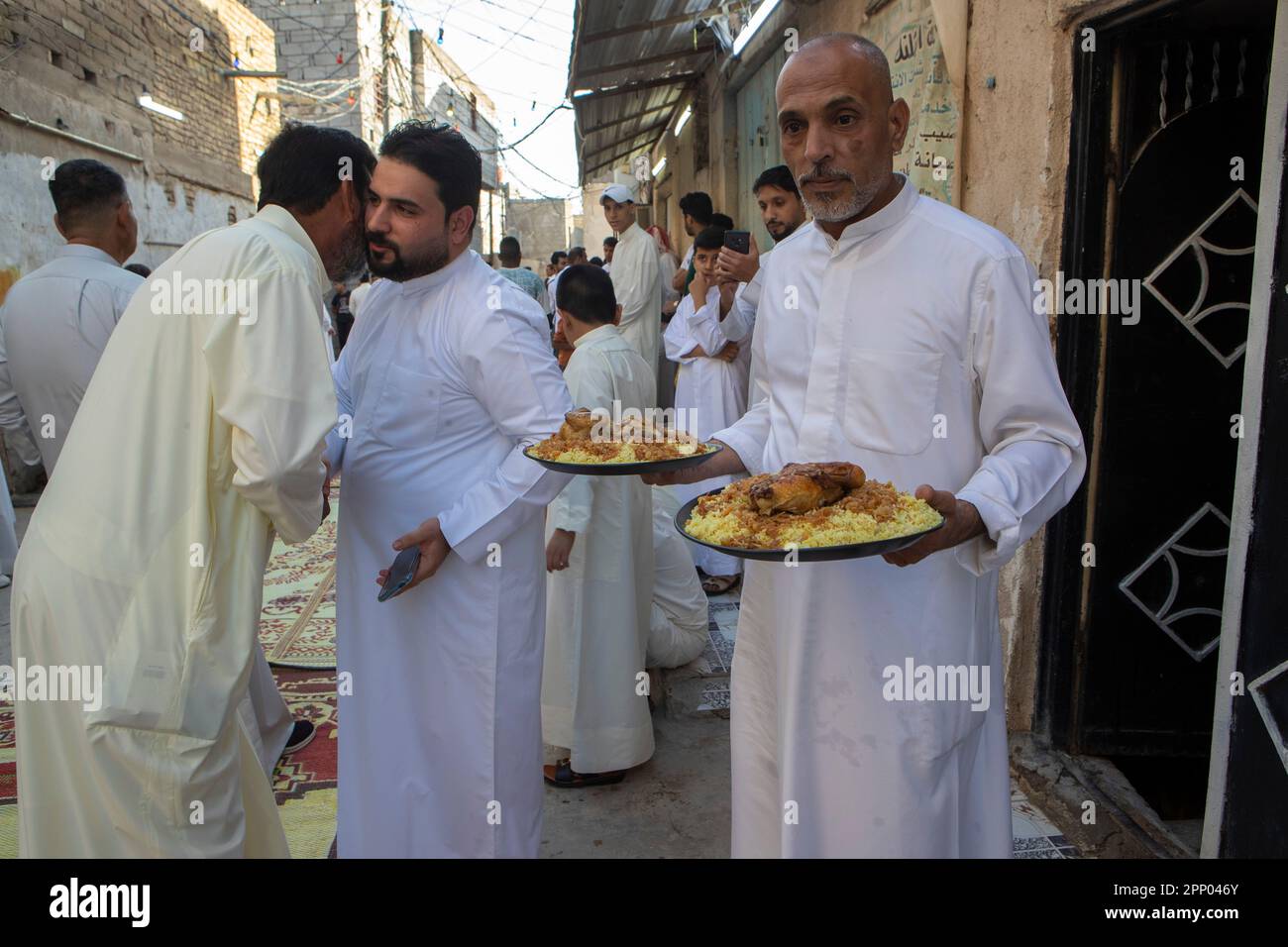 Iraqi Muslims greet each other after prayers on the first day of Eid Al ...