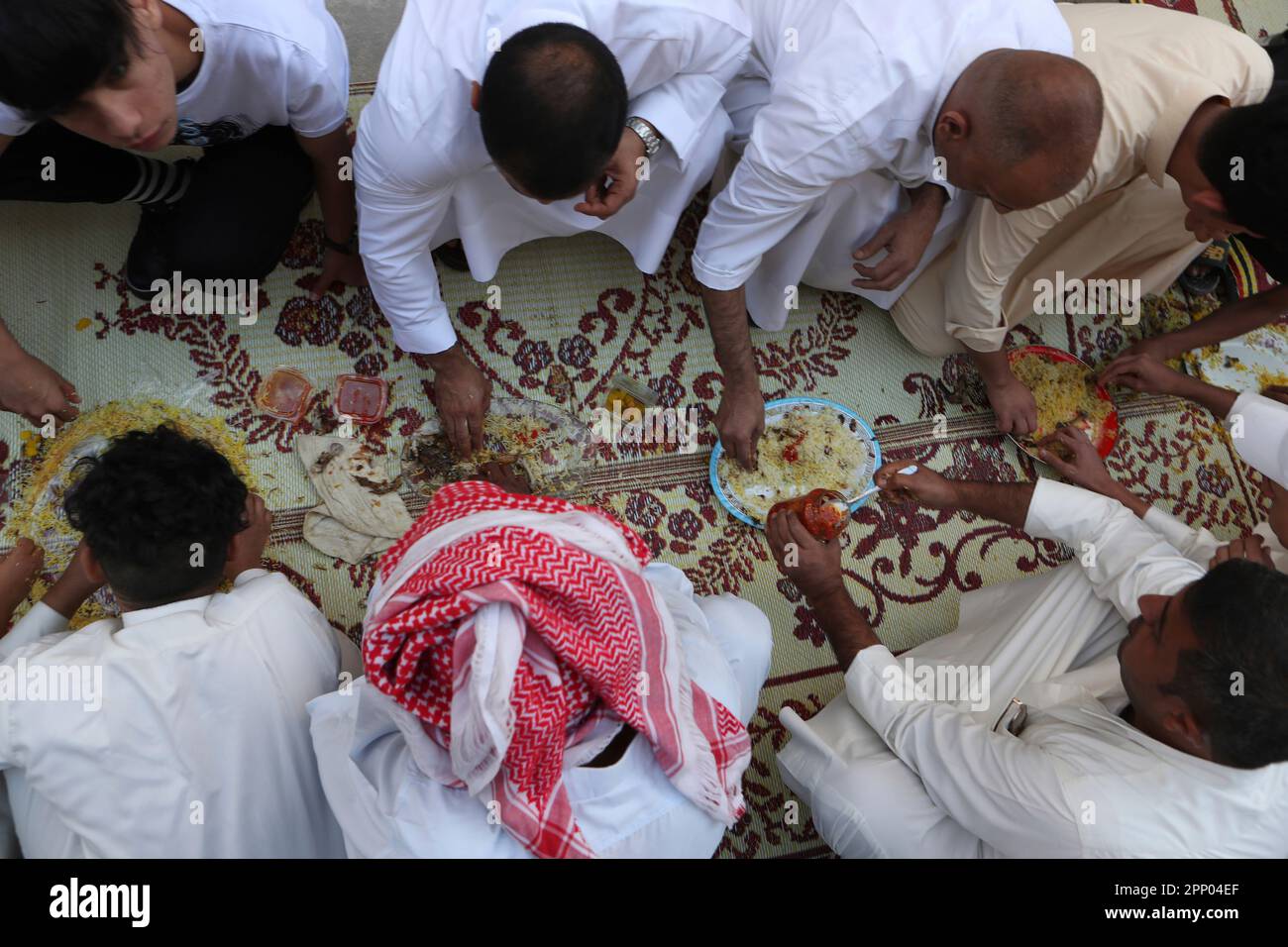 Iraqis eat morning breakfast on the first day of Eid Al-Fitr holiday in ...