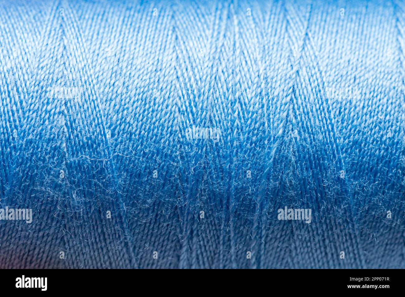 Close-up of blue yarn, fine details of cotton thread, textured ...
