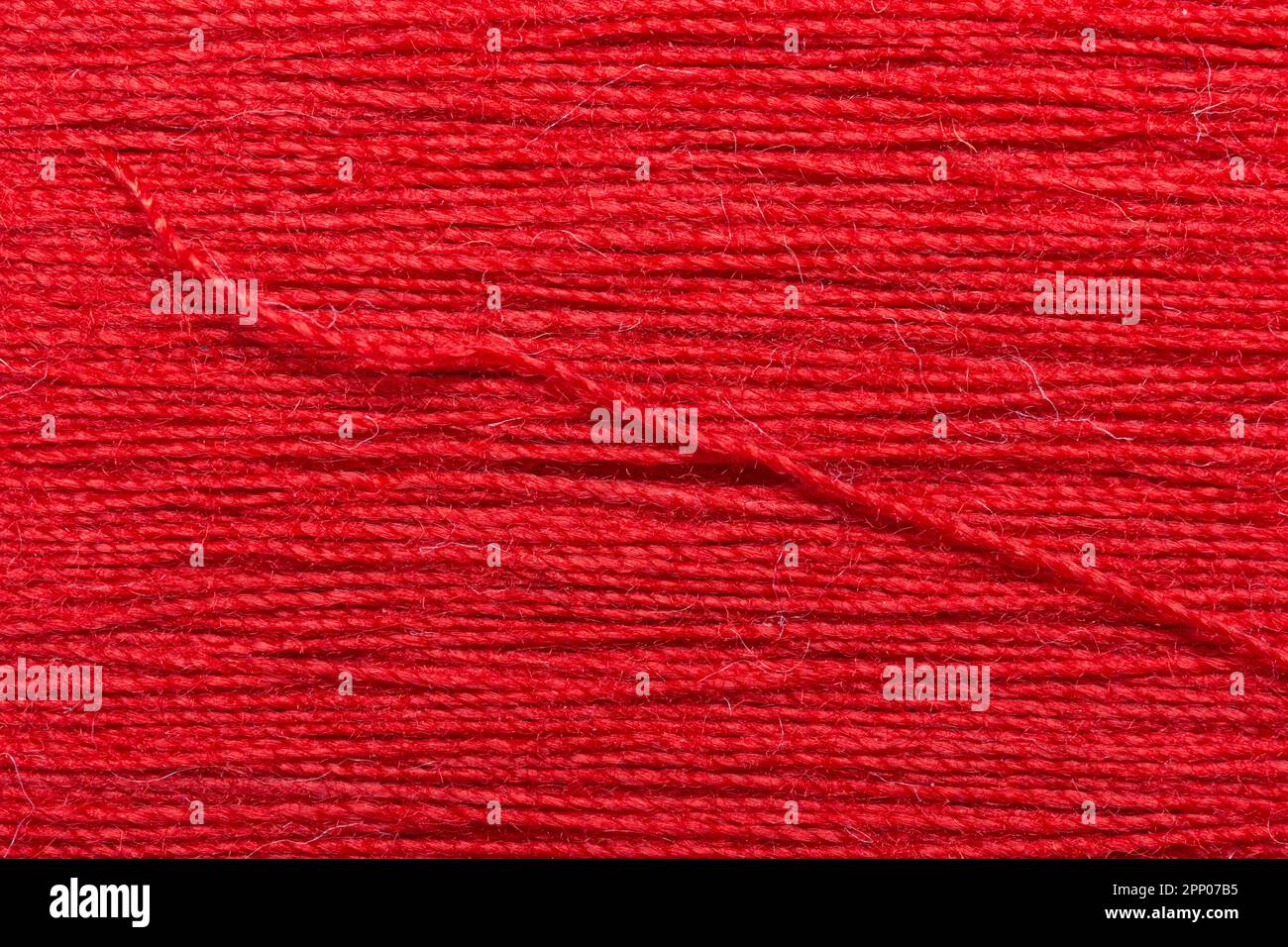 Close-up of red yarn, fine details of cotton thread, textured ...