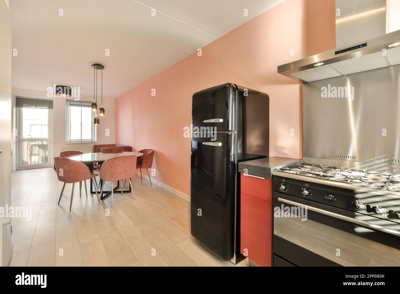 a kitchen with an oven, stove and dining room in the back ground is ...
