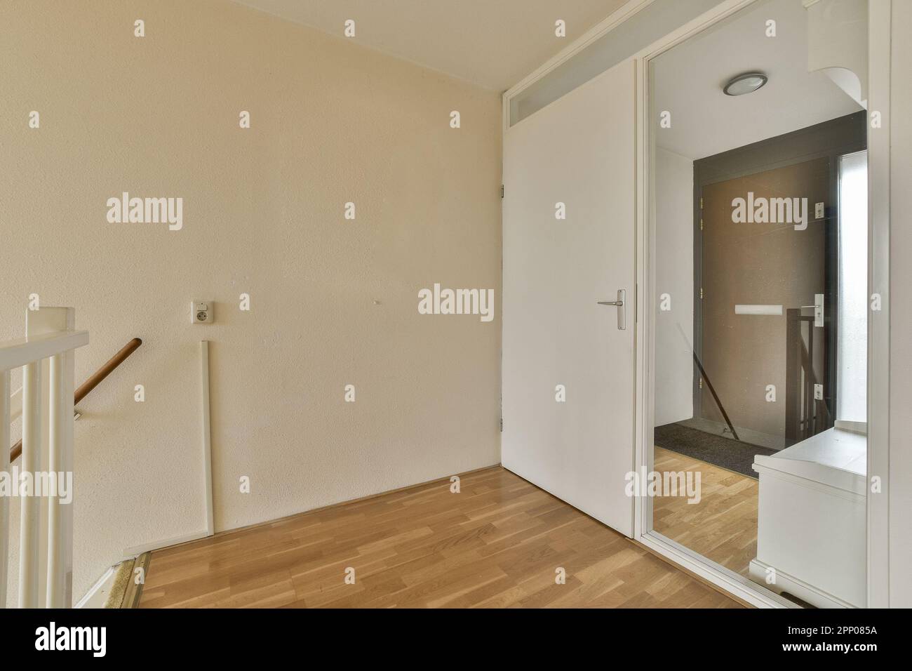 an empty room with wood flooring and white walls, there is a large ...