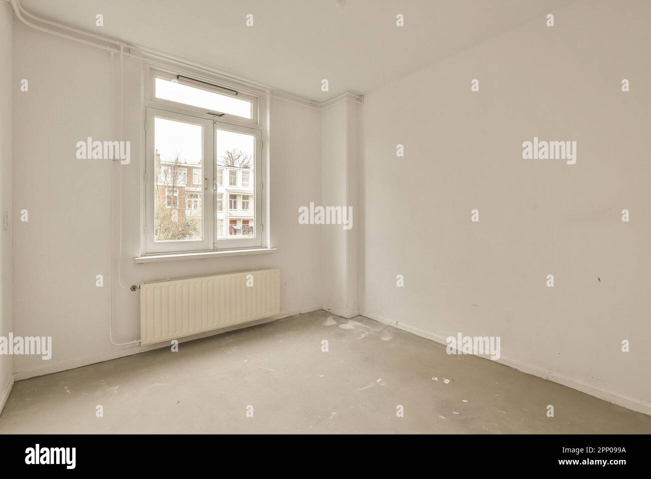 an empty room with white walls and no one person standing on the floor ...