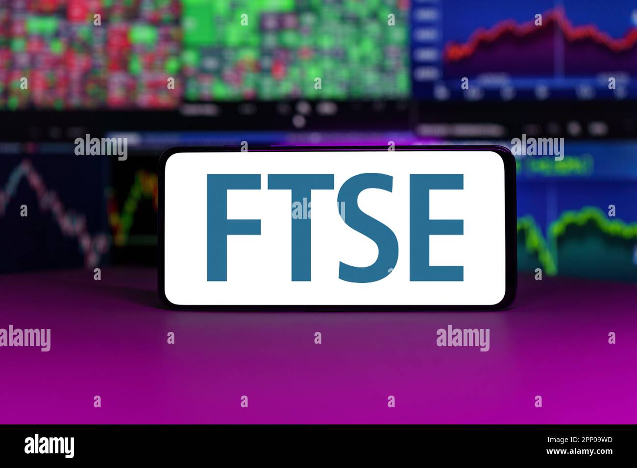 FTSE 100 stock market index in front of stock market charts background ...