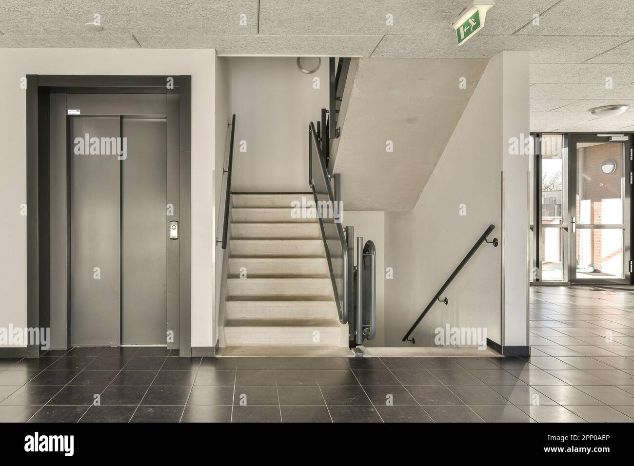 the inside of a building with stairs leading up to some doors and an ...