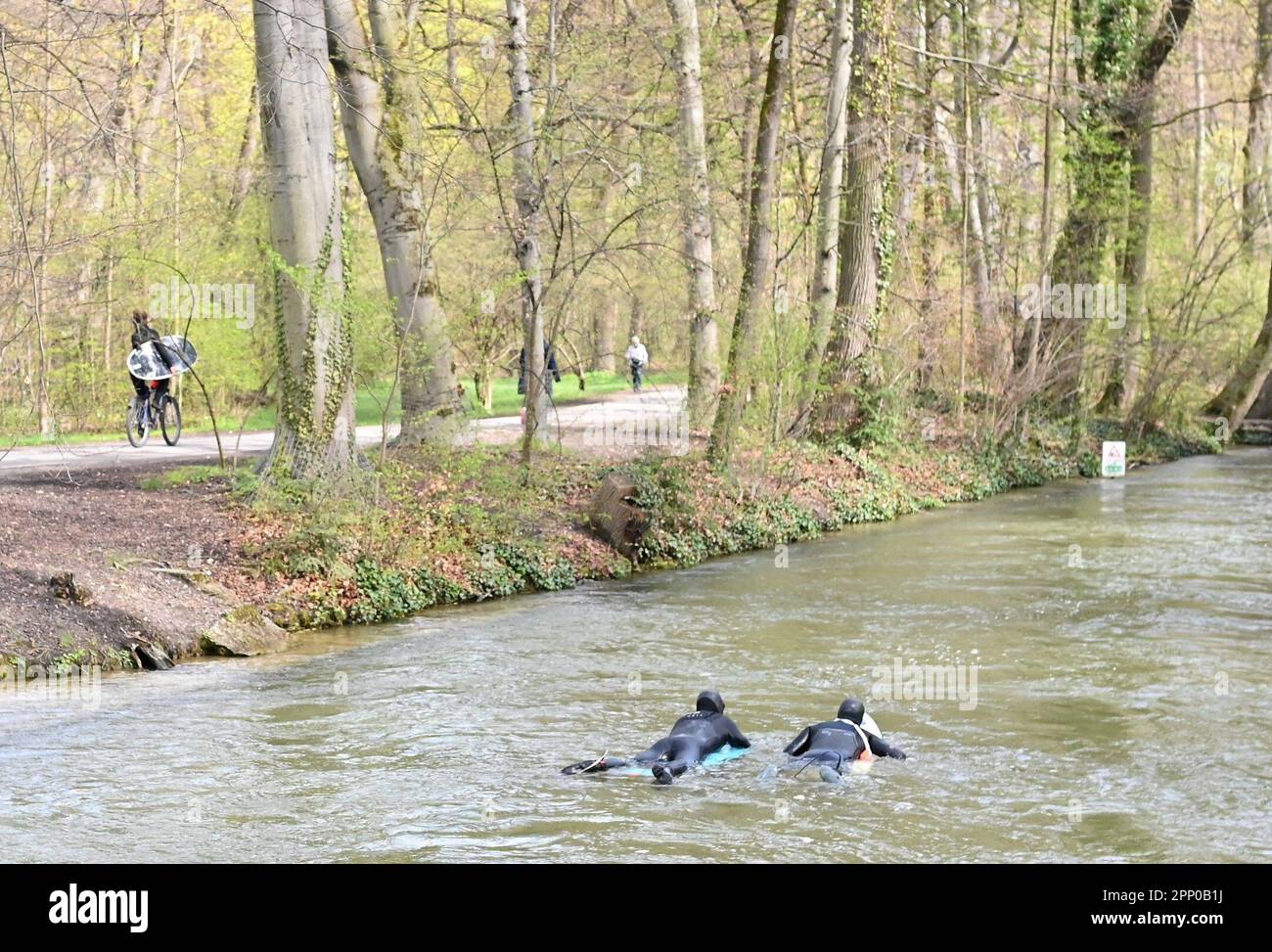 Munich, Germany. 21st Apr, 2023. Two people in wetsuits are floating on ...