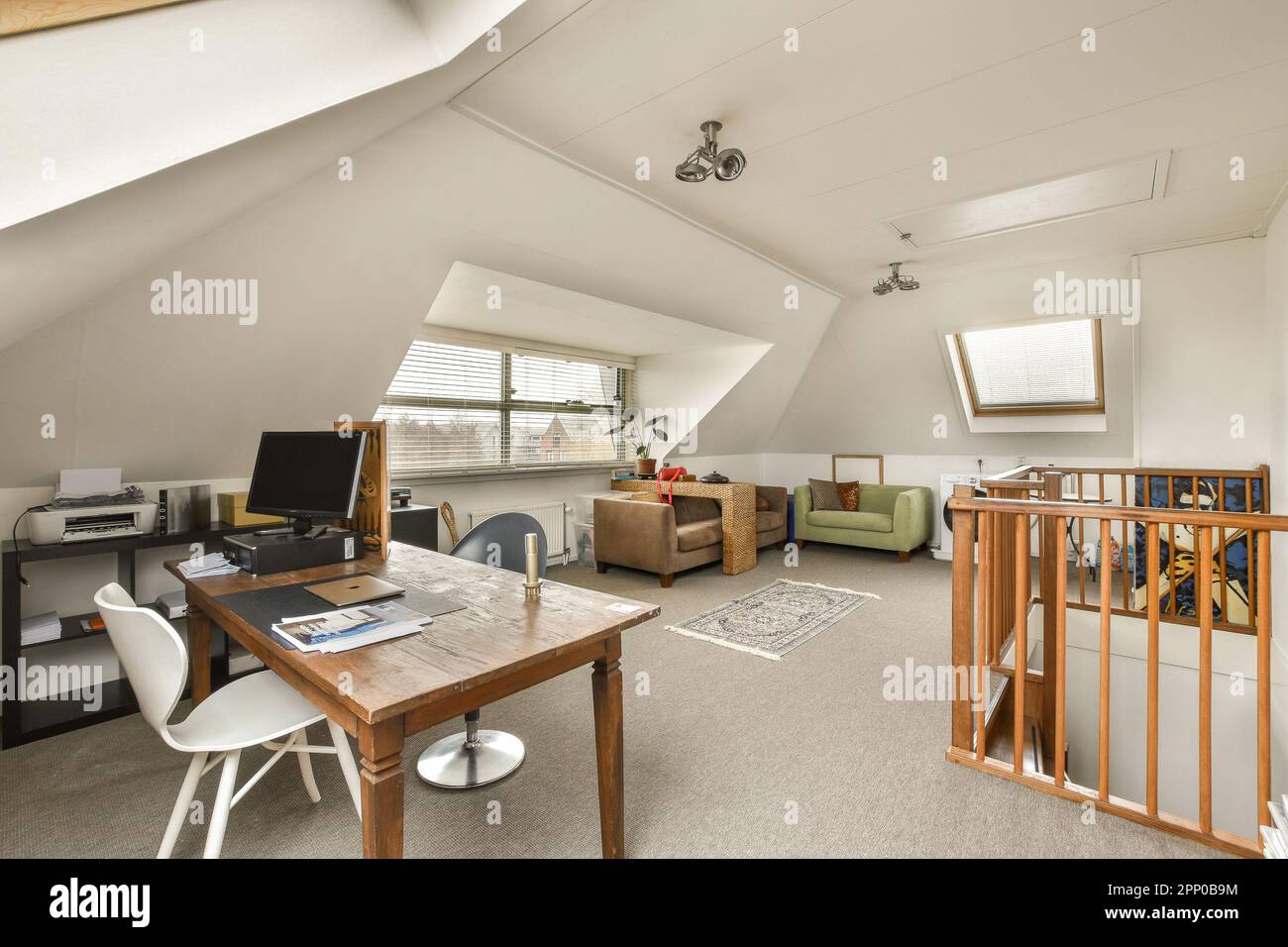 a living room with a desk and computer on the table in front of an open ...
