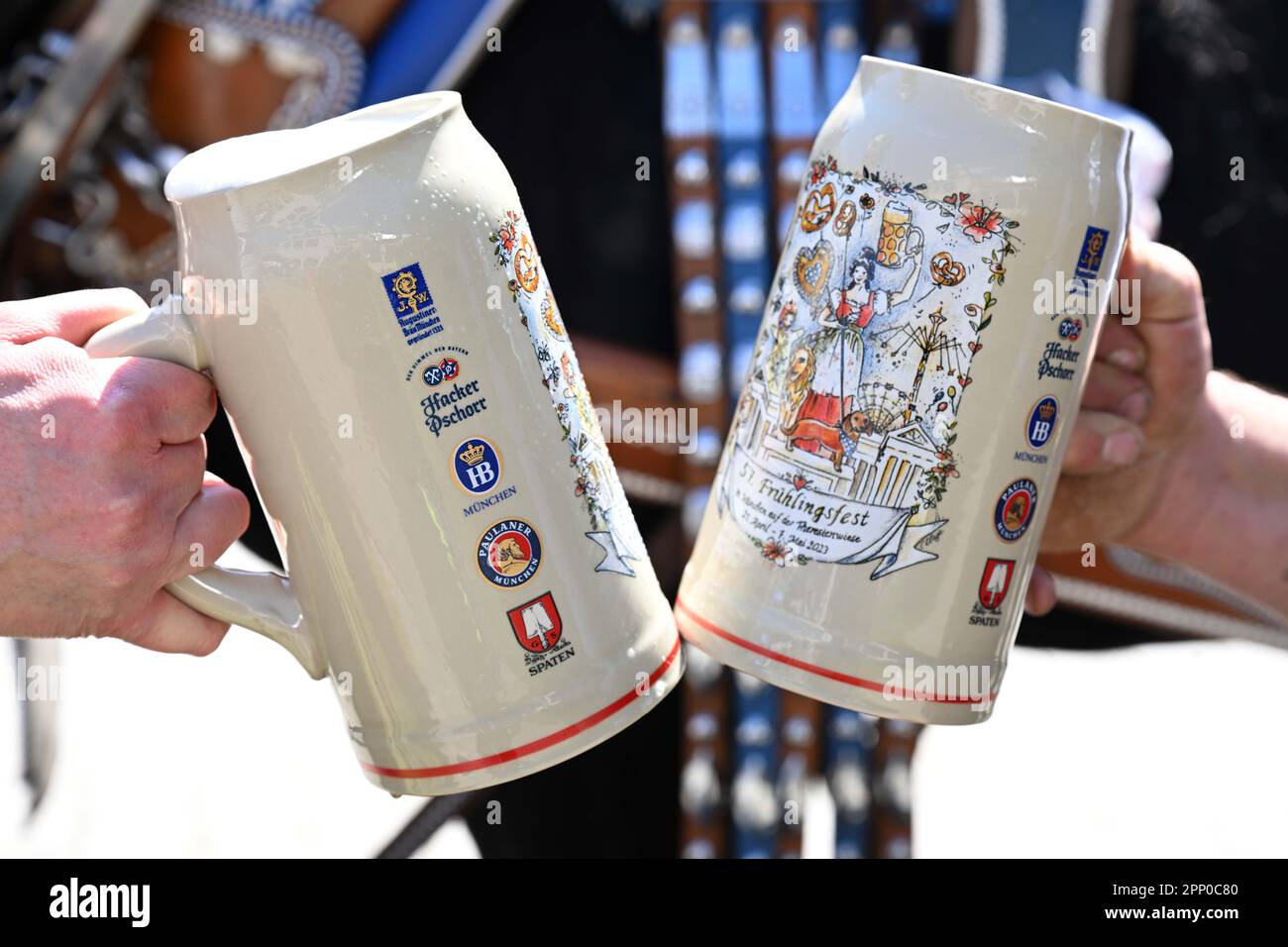 Munich, Germany. 21st Apr, 2023. Two guests toast with beer mugs ...