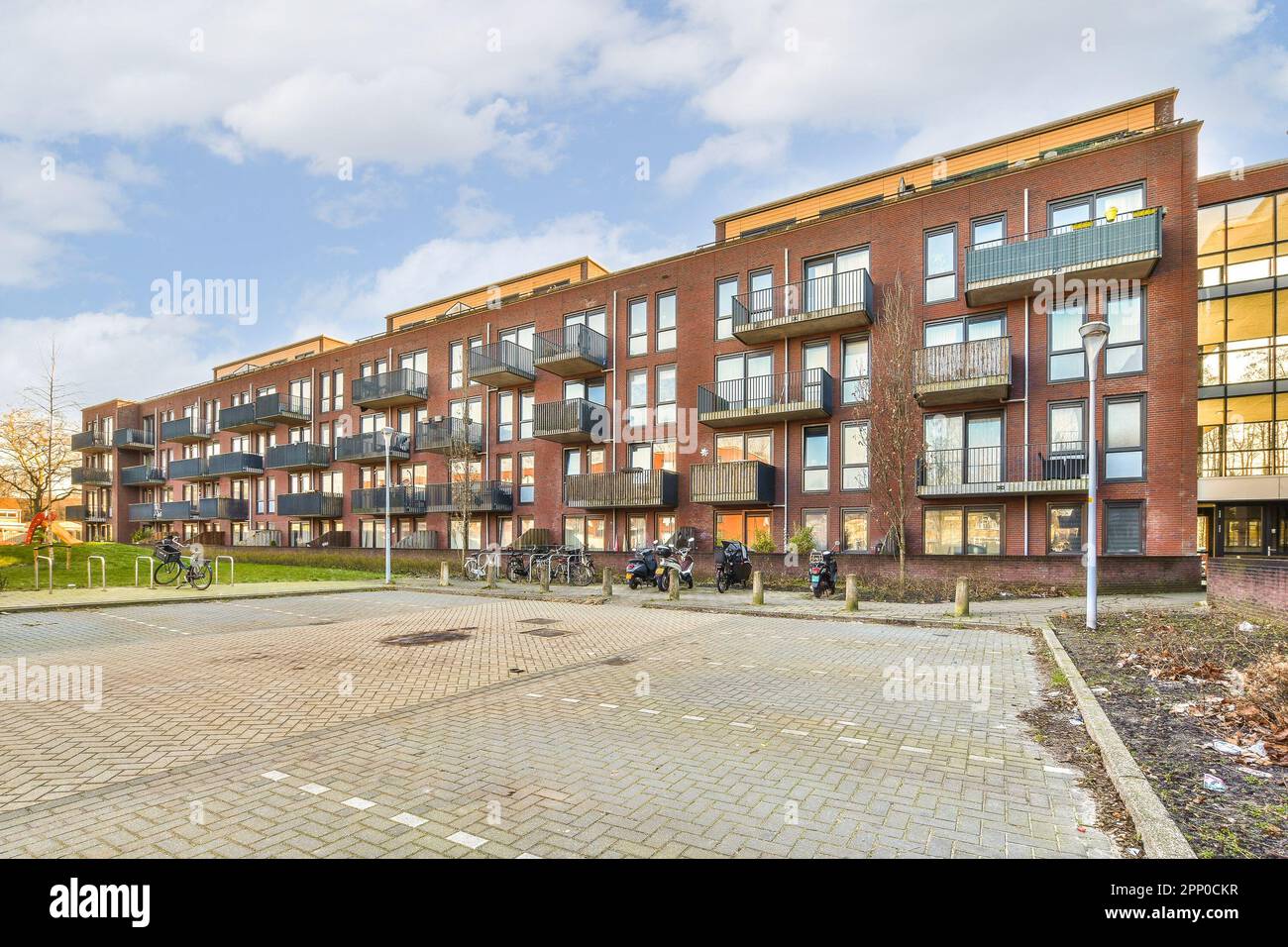 a bricked area in the middle of an apartment complex with bikes parked ...