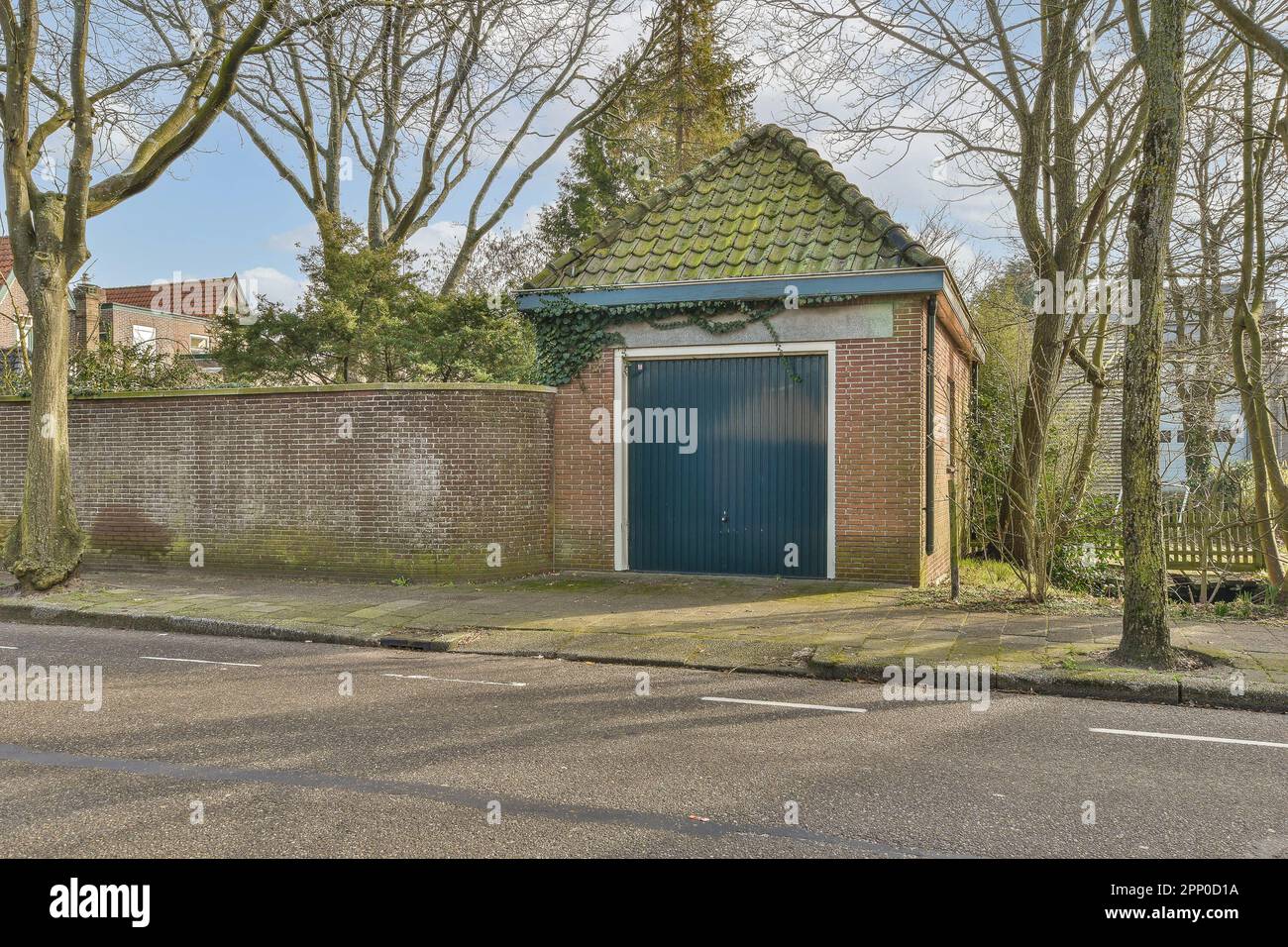 a brick building in the middle of a street with trees on both sides and ...