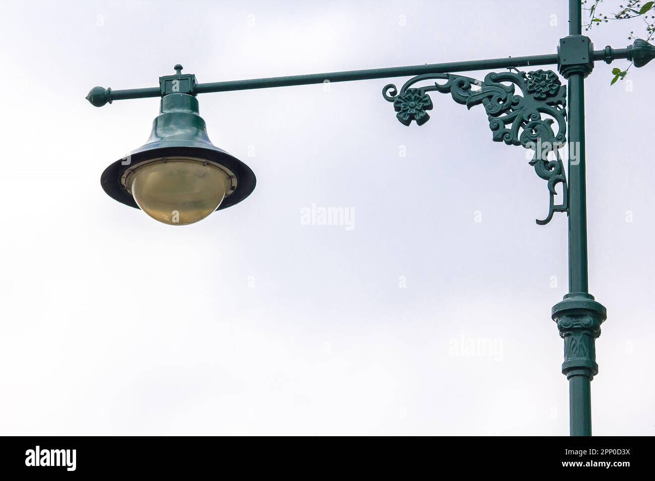 Lamp mounted on a green pole Stock Photo - Alamy