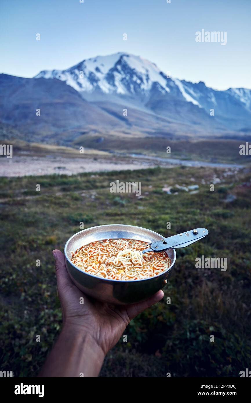 Tourist holding bowl full of noodles fast food and spoon in hand in ...