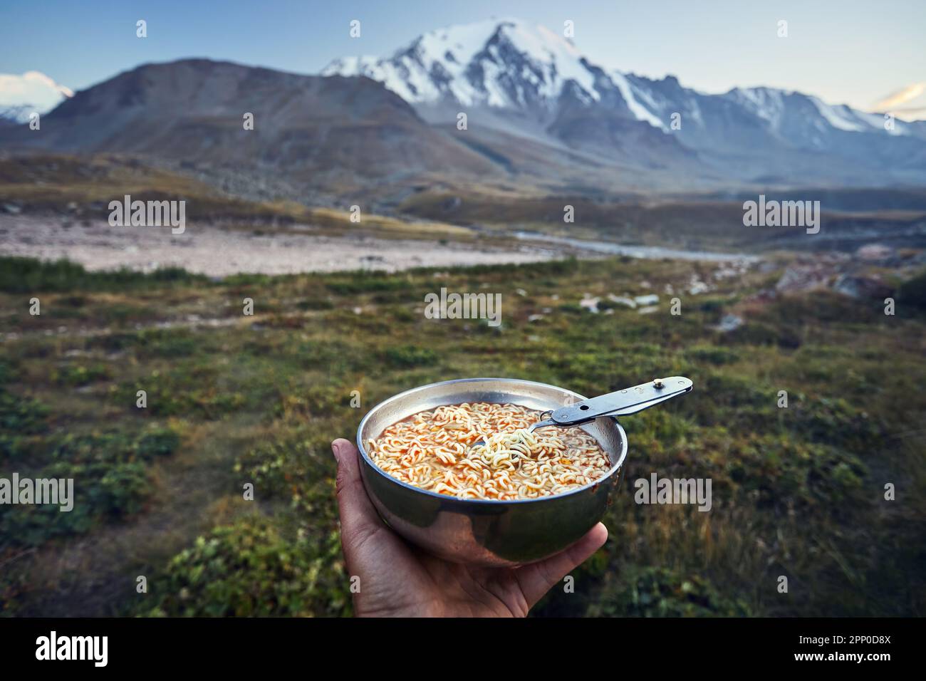 Tourist holding bowl full of noodles fast food and spoon in hand in ...
