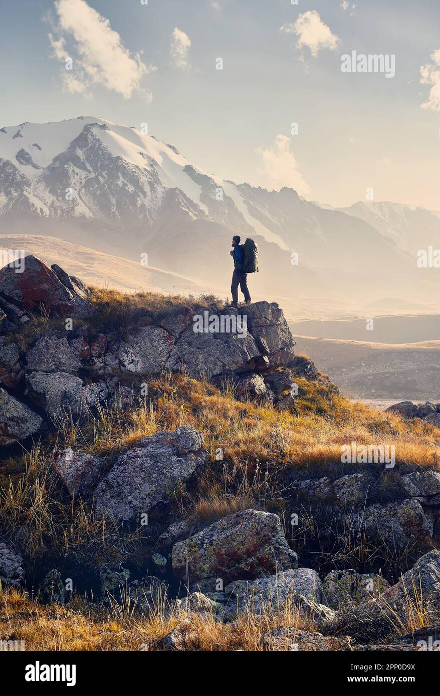Small Man tourist with big backpack is walking climb in the mountain ...