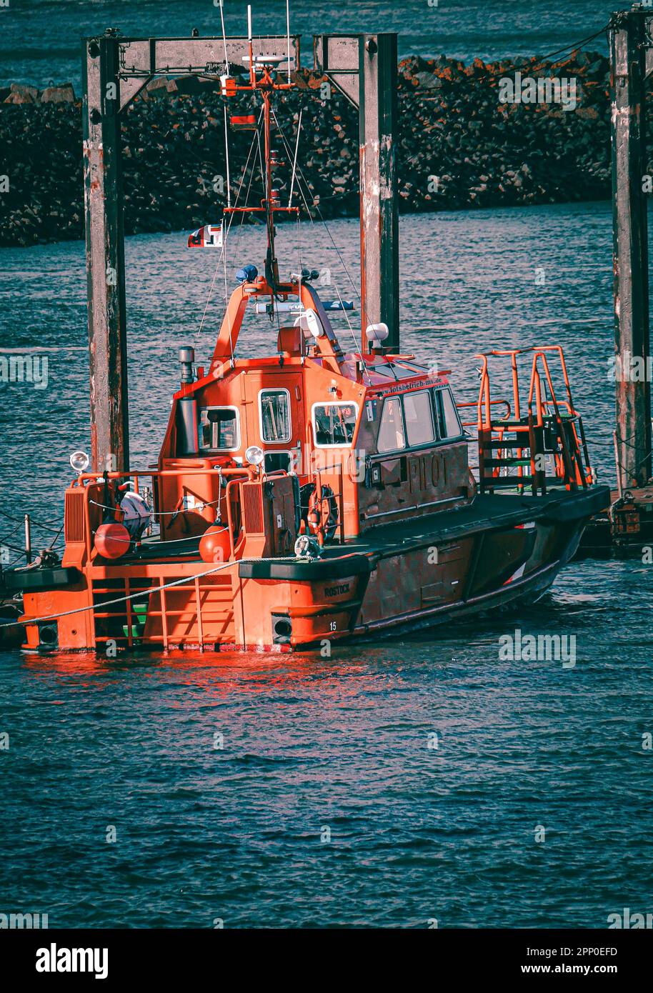 A vibrant orange lifeboat moored at a dock, Cuxhaven, Germany Stock ...