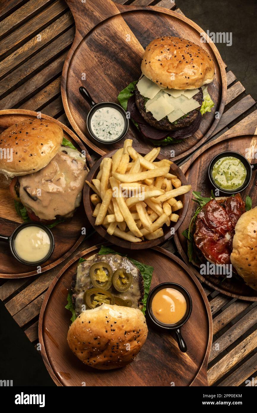 many different gourmet burgers selection on restaurant wood table Stock ...
