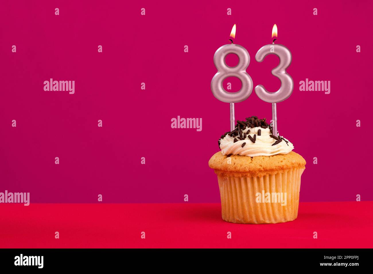Birthday cake with candle number 83 - Rhodamine Red foamy background ...
