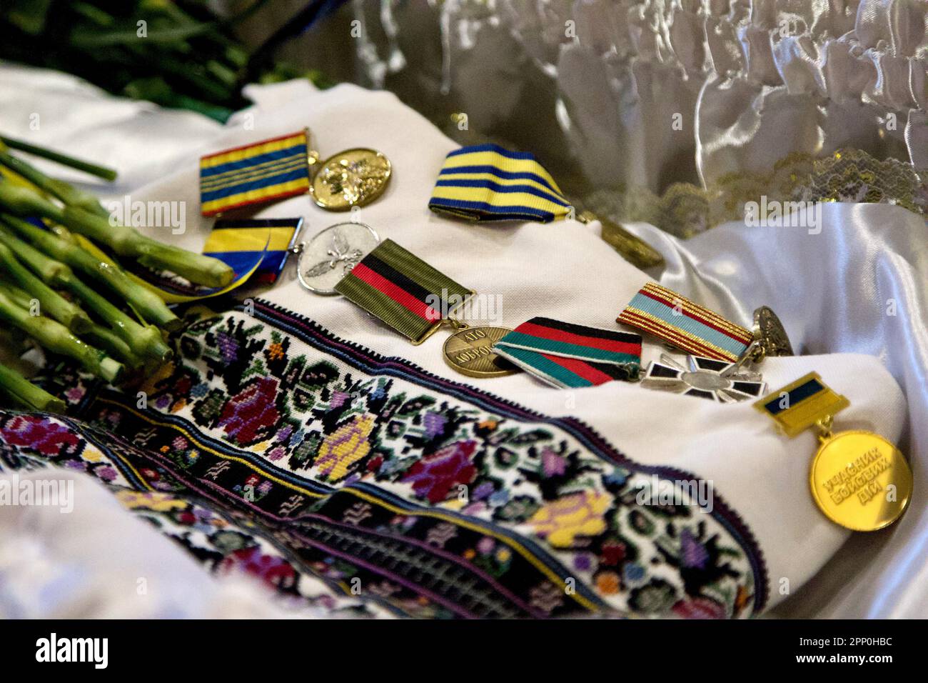 KYIV, UKRAINE - APRIL 21, 2023 - Medals are arranged on a vyshyvanka ...