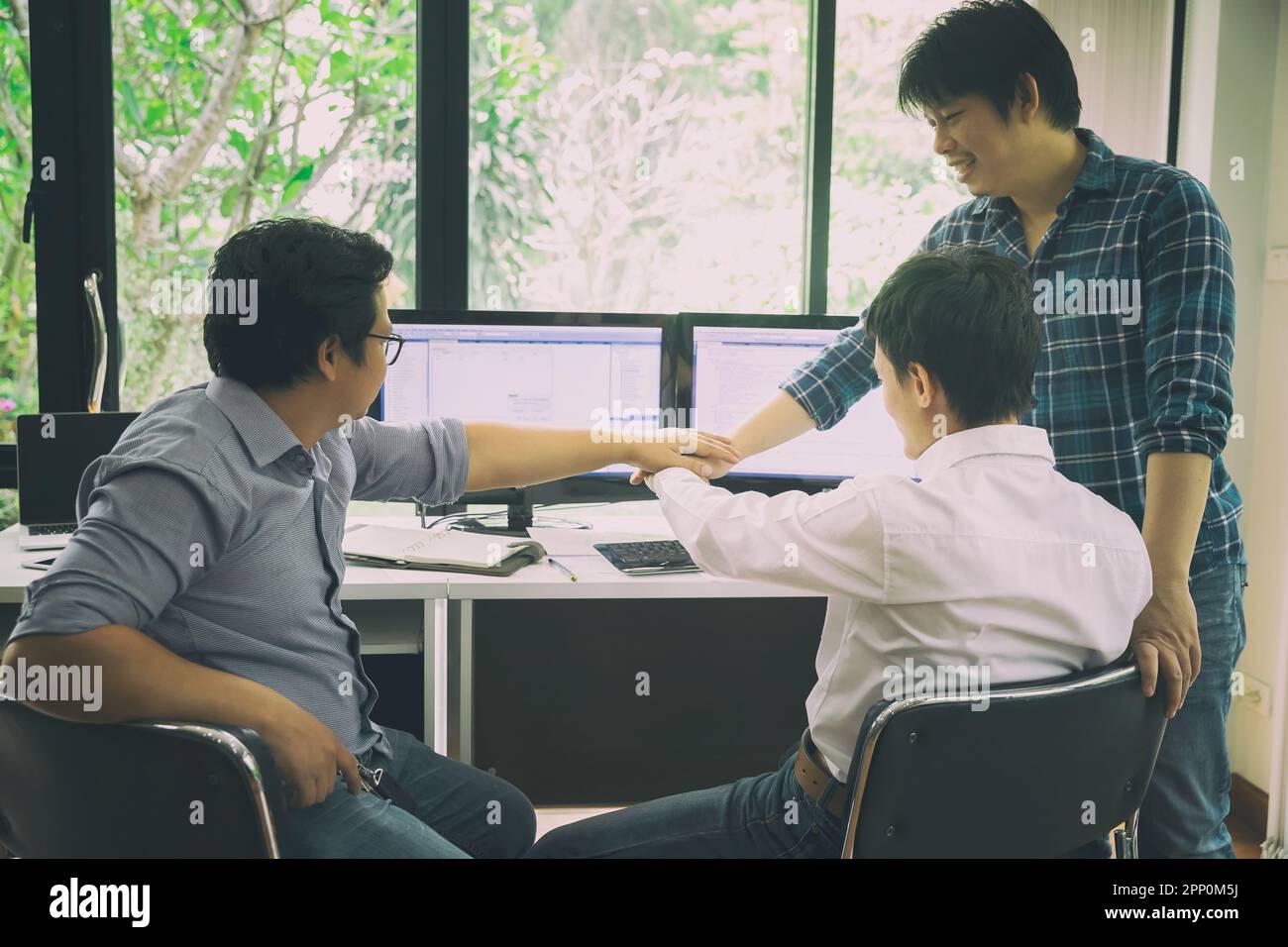 Programmers team joined hands in a software developing. Developing ... Programmers team joined hands in a software developing. Developing ...