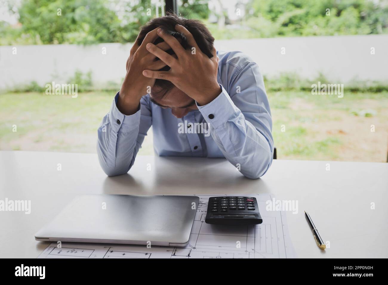 Architect in stress, tired, sad, disappointed with project problem ...