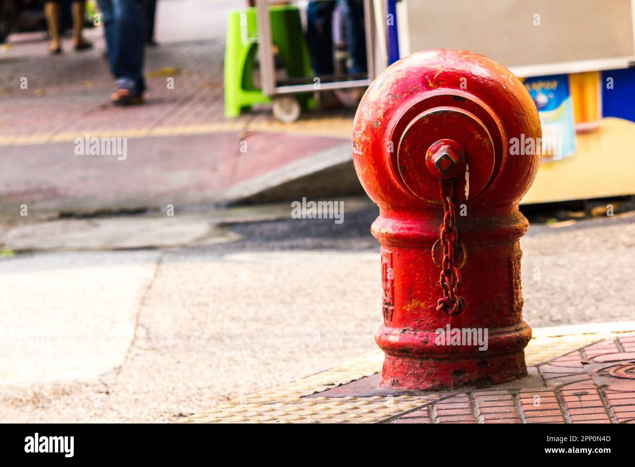 Fire extinguisher is located on the footpath of the road Stock Photo ...