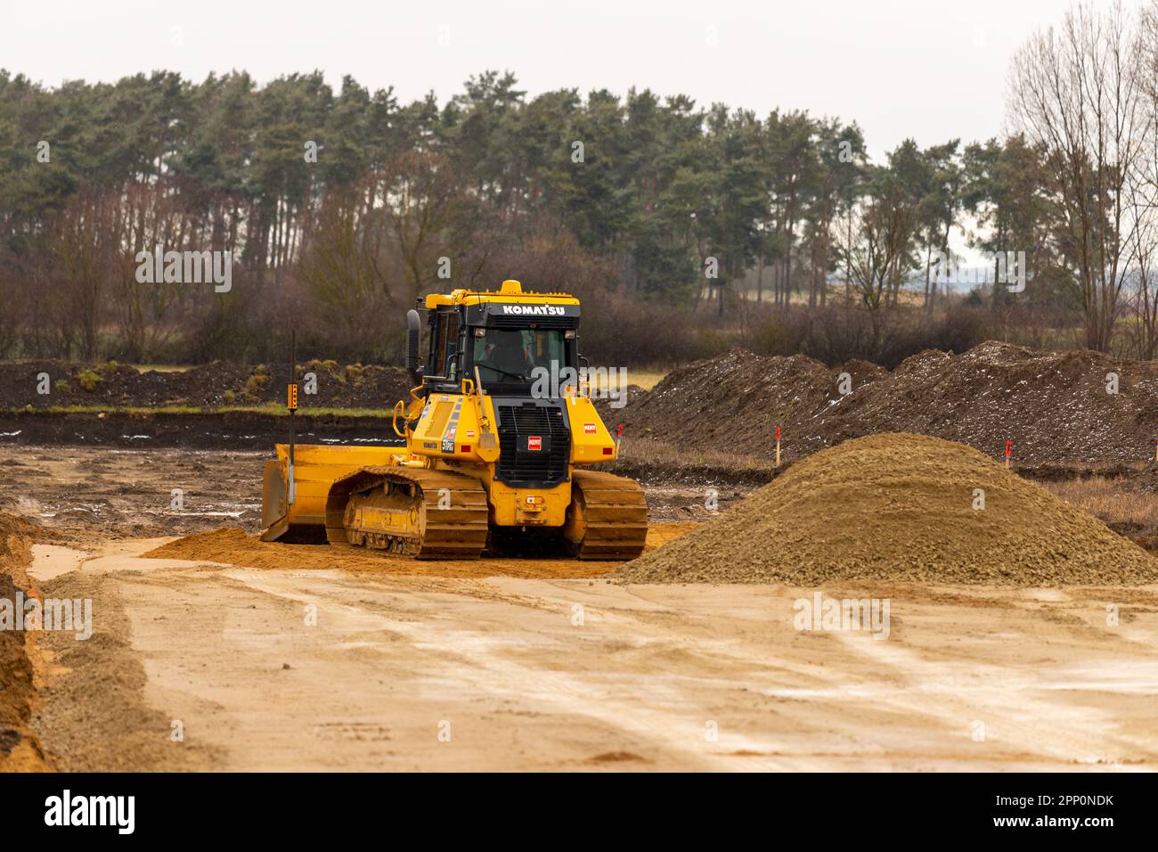 Bulldozer from behind, standing on a mineral mixture construction site ...