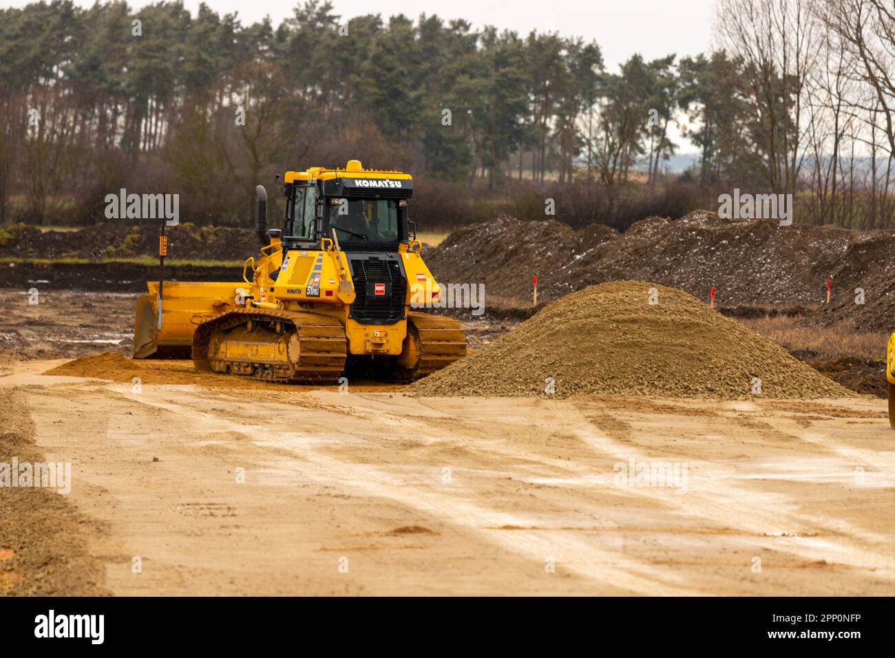 Bulldozer from behind, standing on a mineral mixture construction site ...