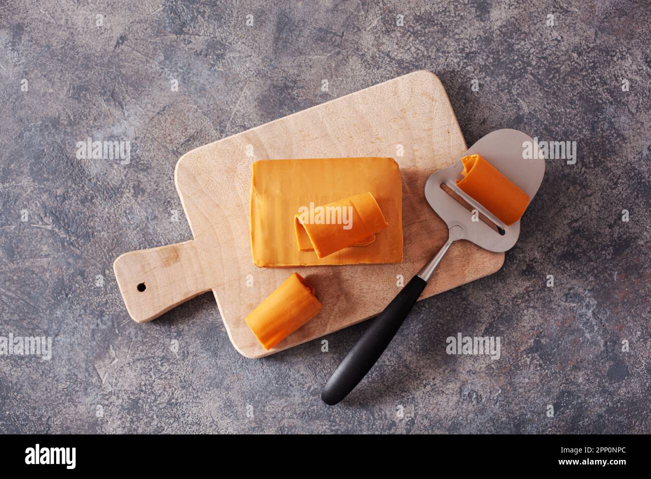 Norwegian brunost traditional brown cheese block and slicer Stock Photo ...