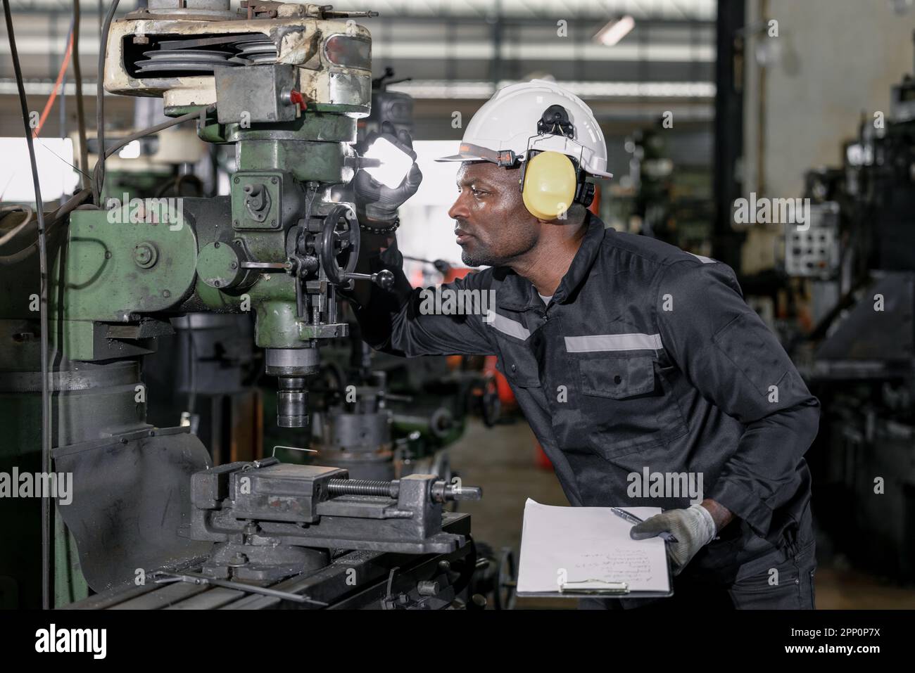 Skilled robotic technician spots the light on robotic components to do ...