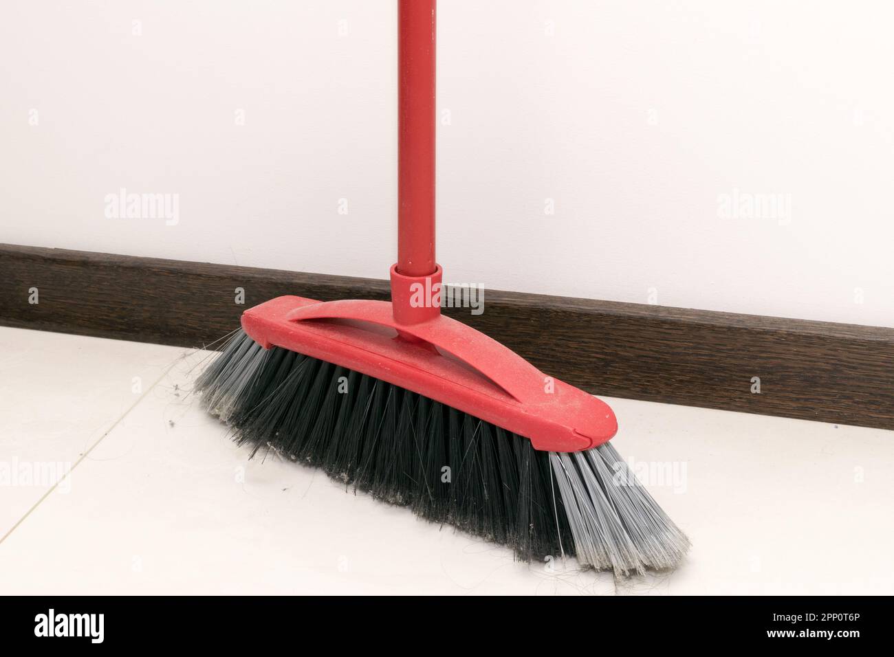 View of the red sweeping brush in the kitchen Stock Photo - Alamy