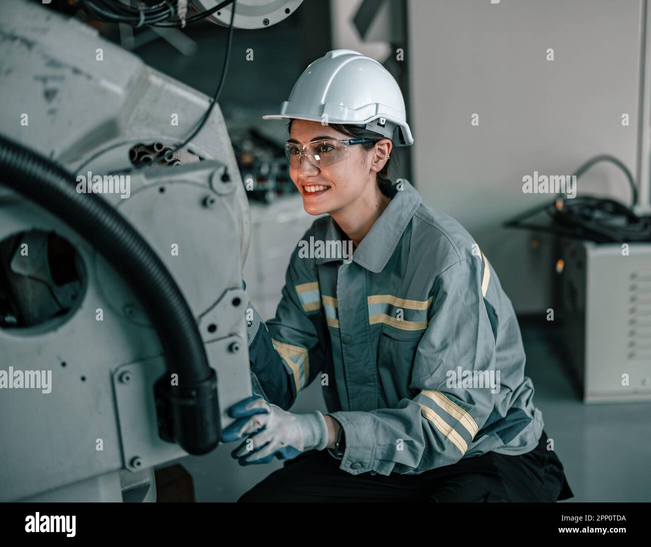 Skilled robotic technician spots the light on robotic components to do ...