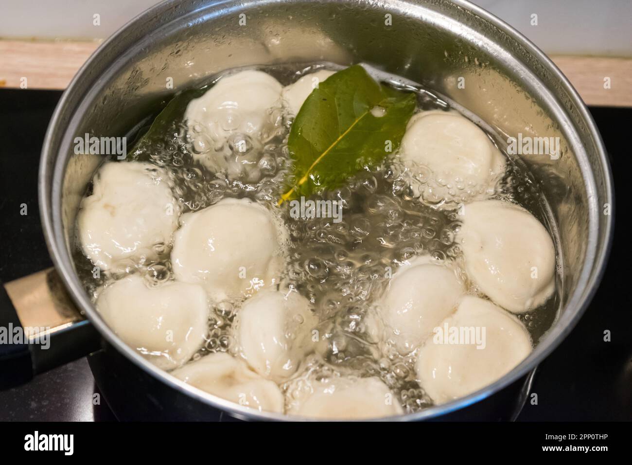 Cooking russian pelmeni. A pot of boiled pelmeni, approx. Boiled water ...