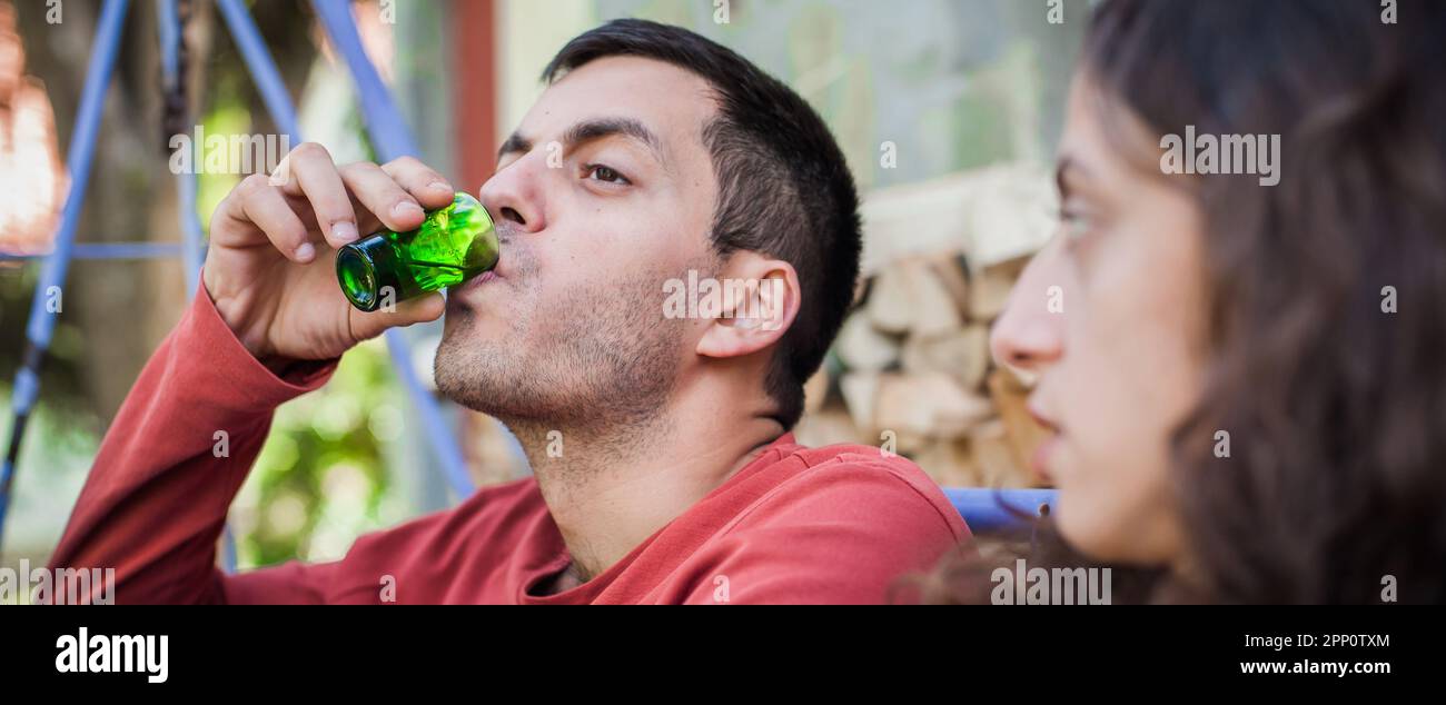 Very drunk couple, a boy and a girl, drink a strong alcoholic drink ...
