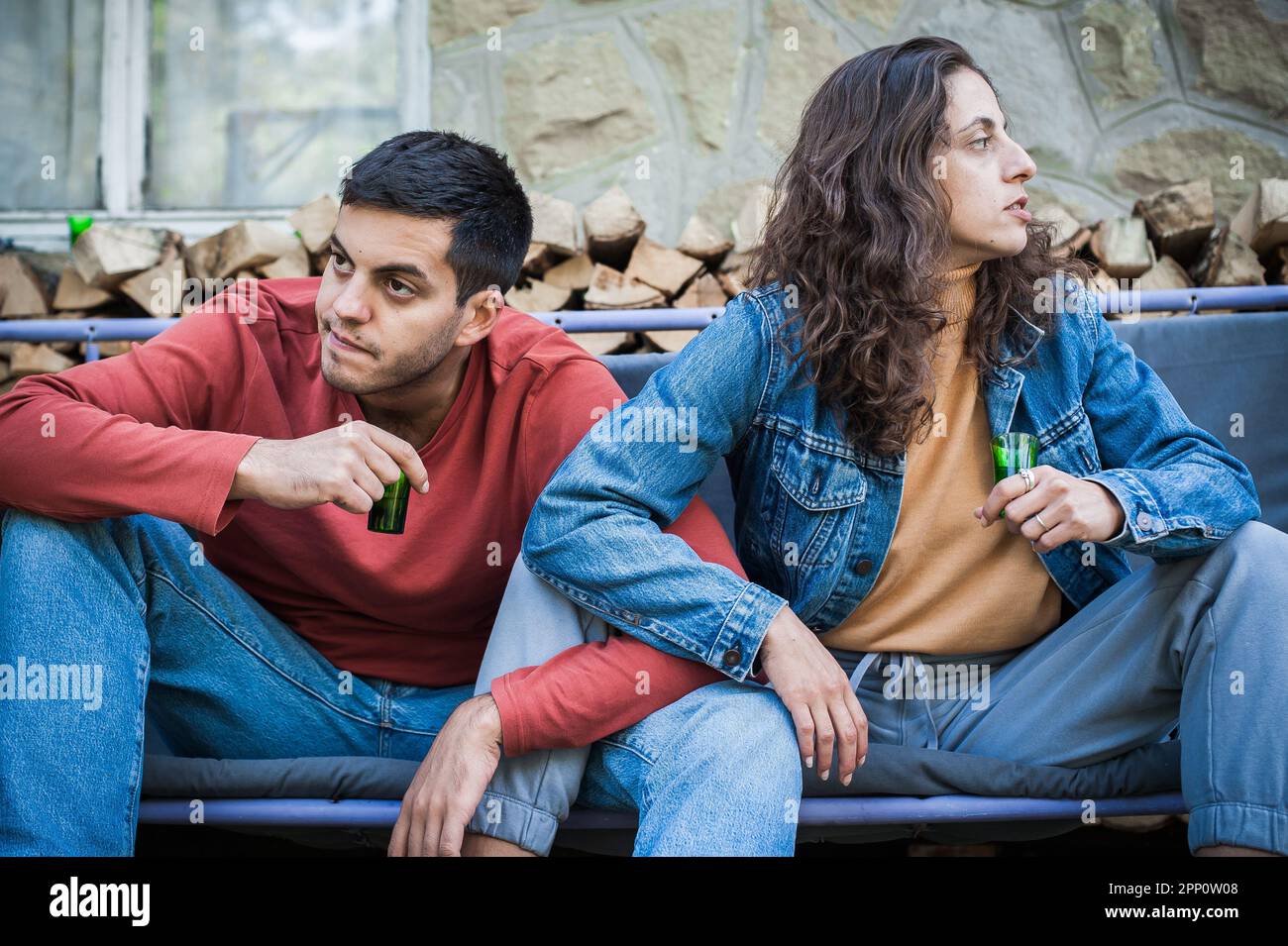 Very drunk couple, a boy and a girl, drink a strong alcoholic drink ...