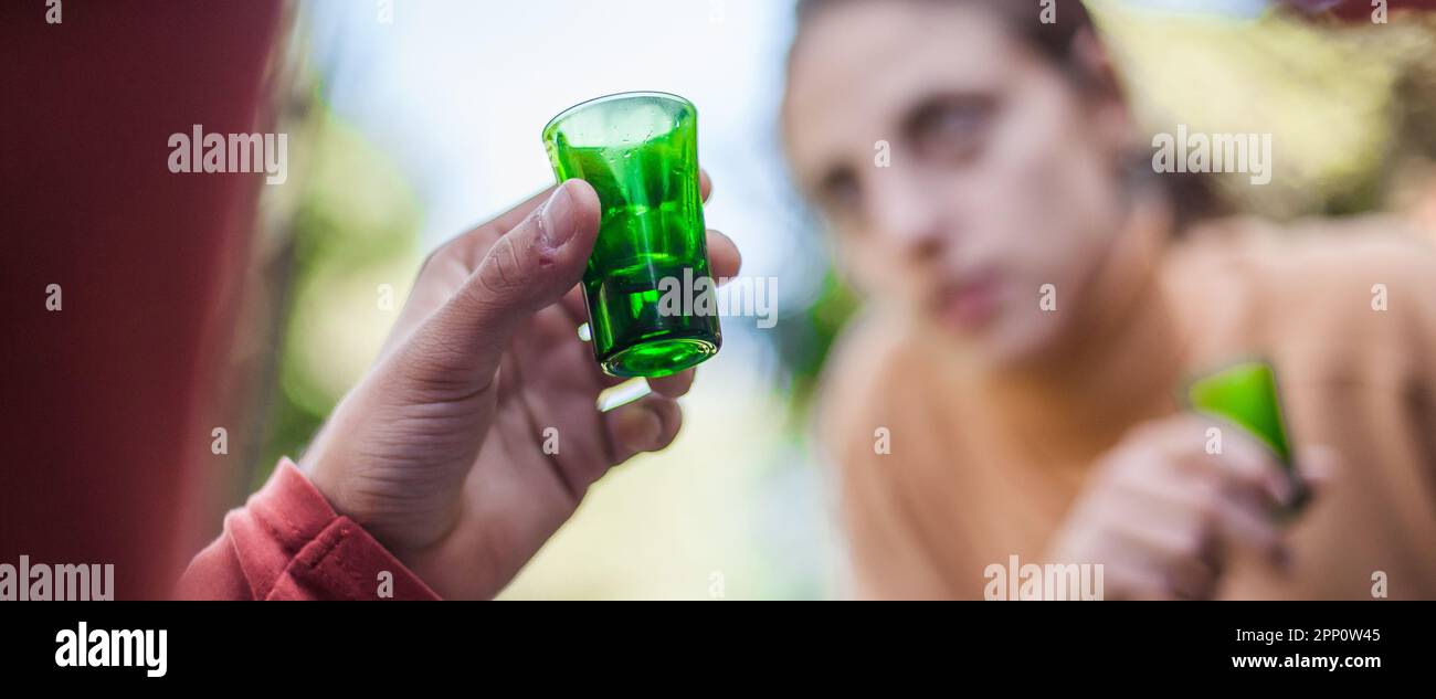 Very drunk couple, a boy and a girl, drink a strong alcoholic drink ...