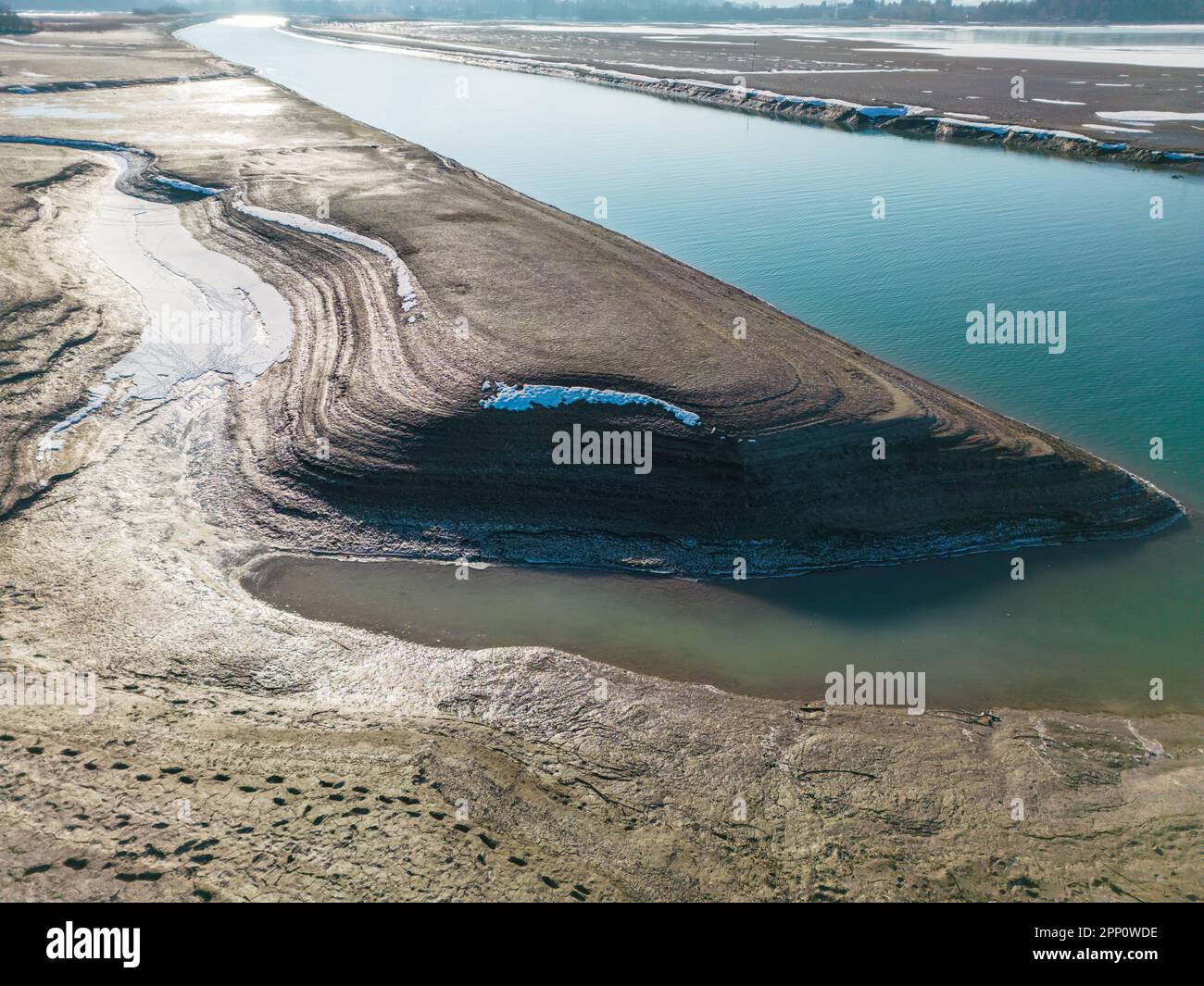 An aerial view of a stunning seascape and snowy coast in Forggensee ...