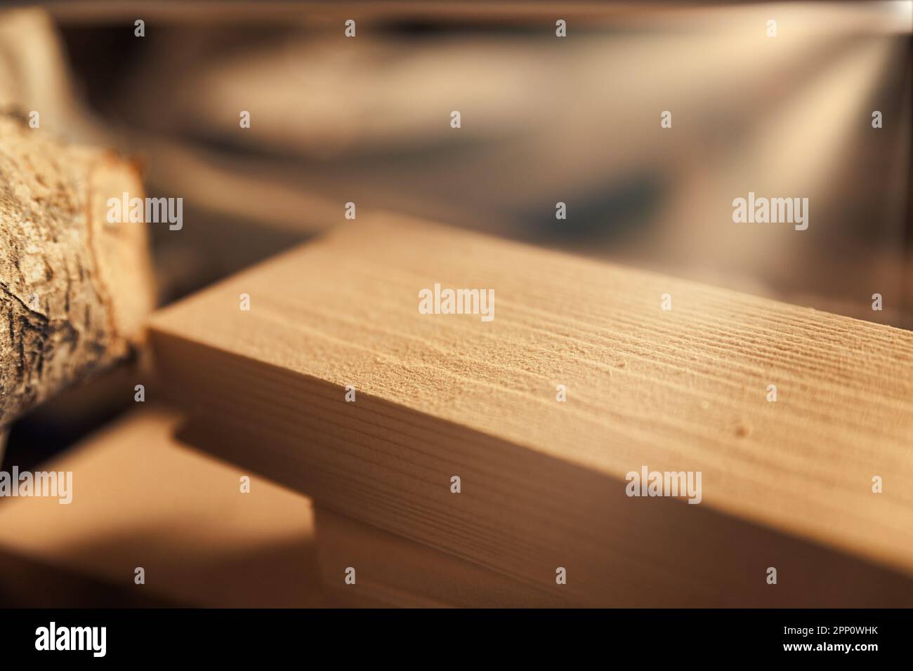 Rays of light streaming in through the large window of a carpentry shop ...