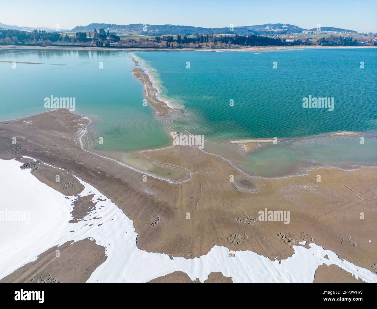 An aerial view of a stunning seascape and snowy coast in Forggensee ...
