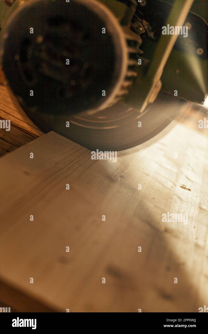 Wood saw while cutting lumber in a woodworking shop Stock Photo - Alamy