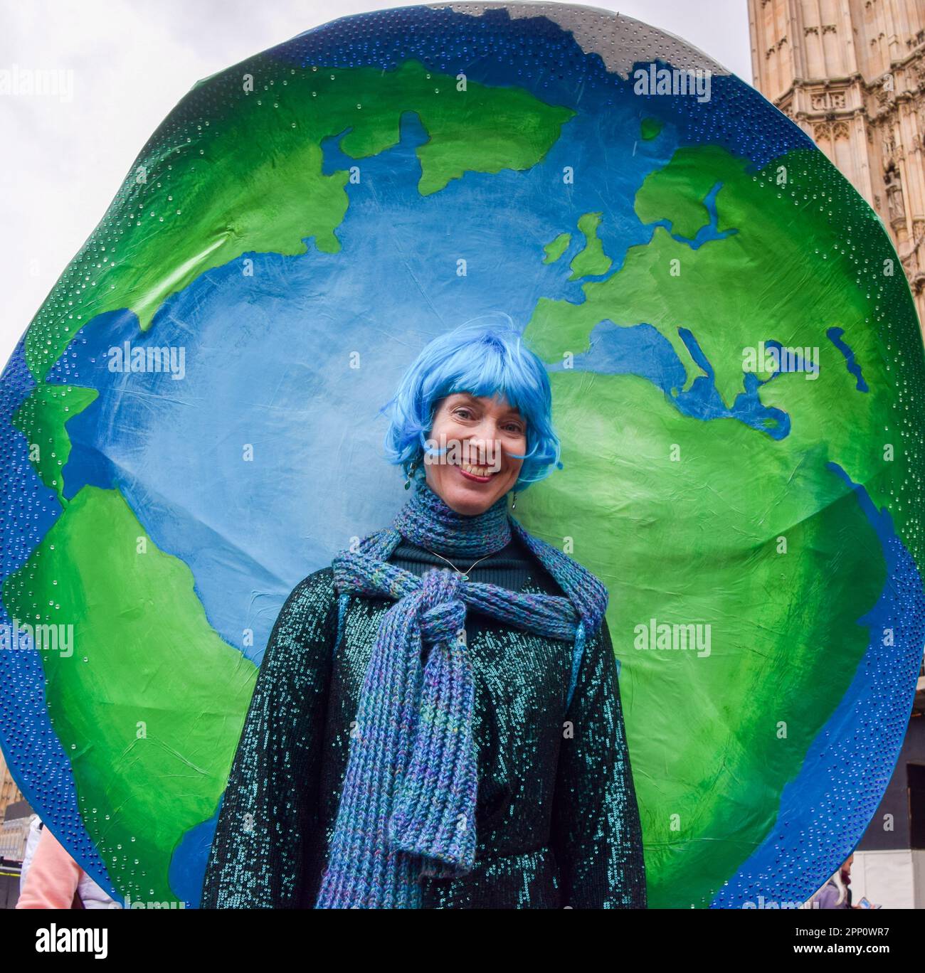 London, UK. 21st April 2023. A protester wears an elaborate Earth ...