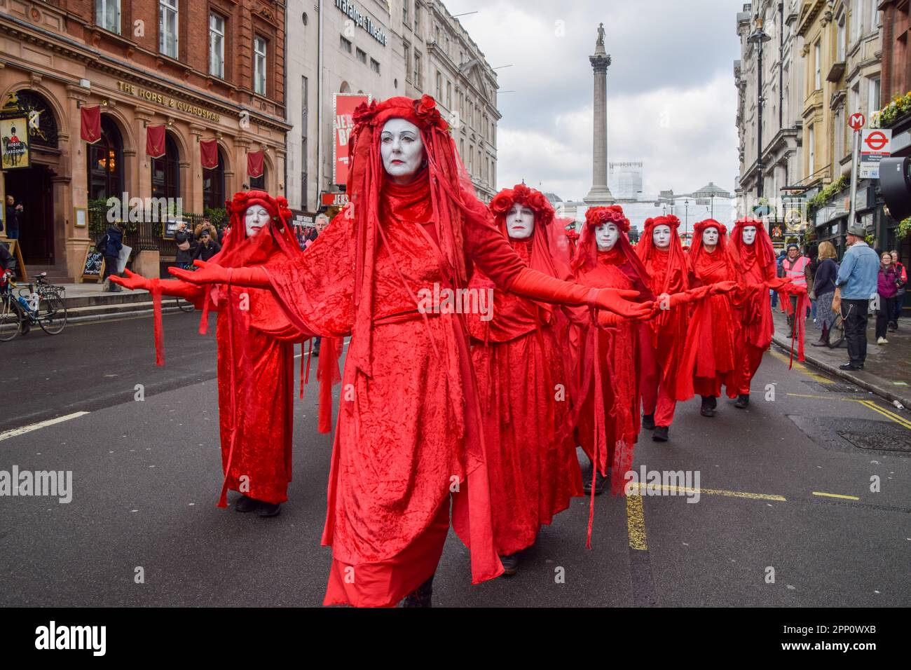 London, UK. 21st April 2023. Red Rebels pass through Whitehall as Extinction Rebellion begin ...